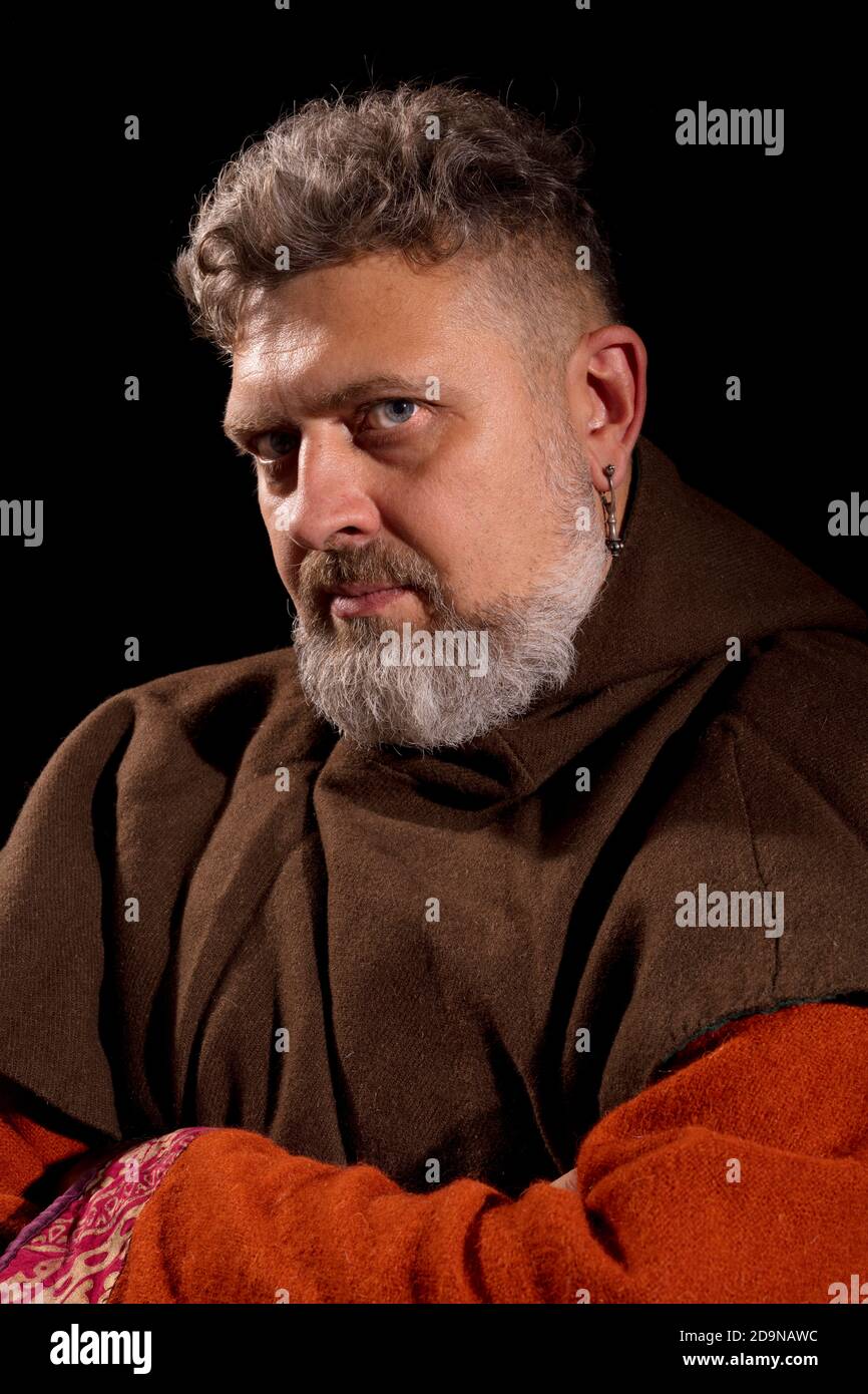 Mature bearded man in traditional historic clothes studio portrait ...