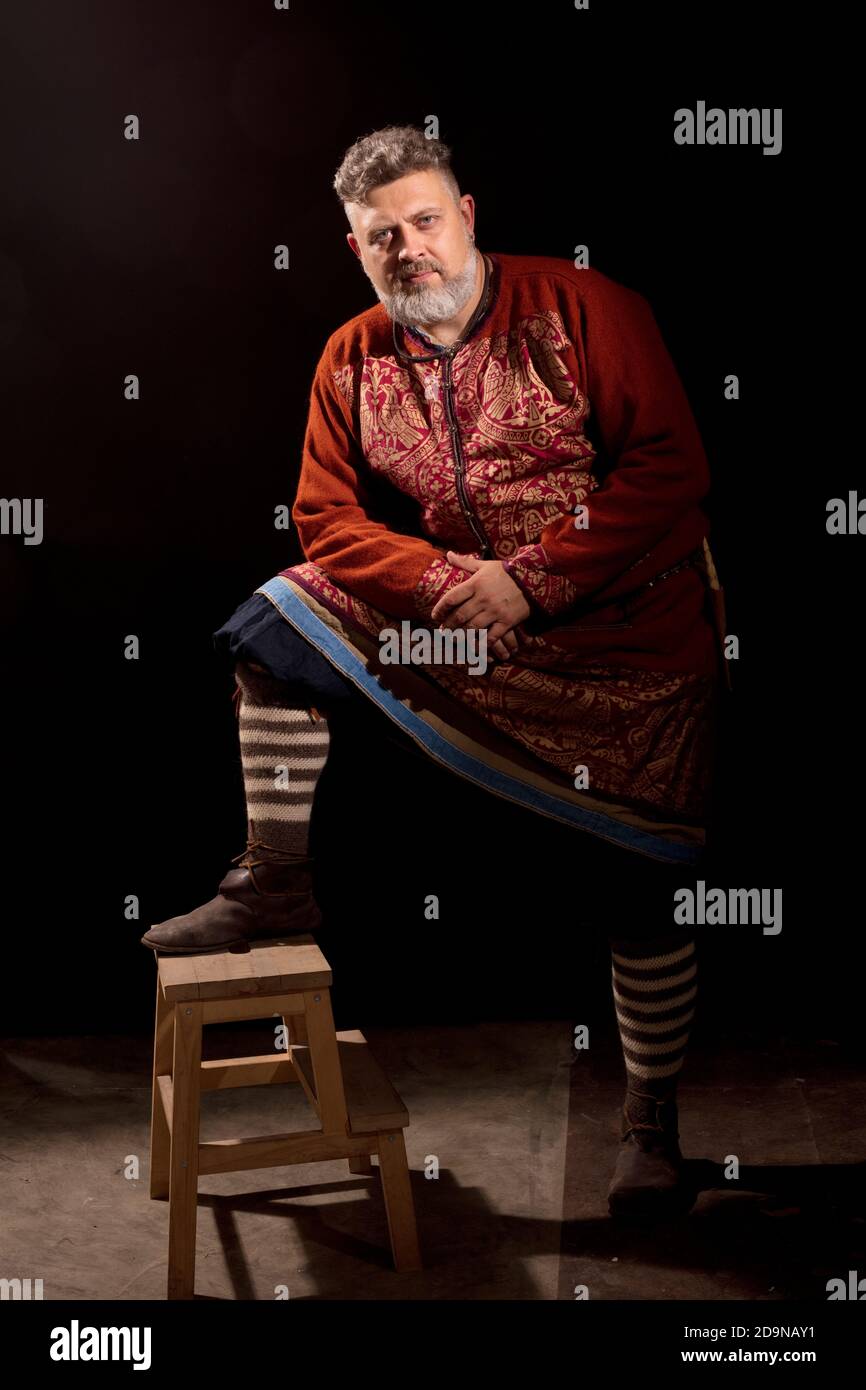 Mature bearded man in traditional historic clothes studio portrait ...