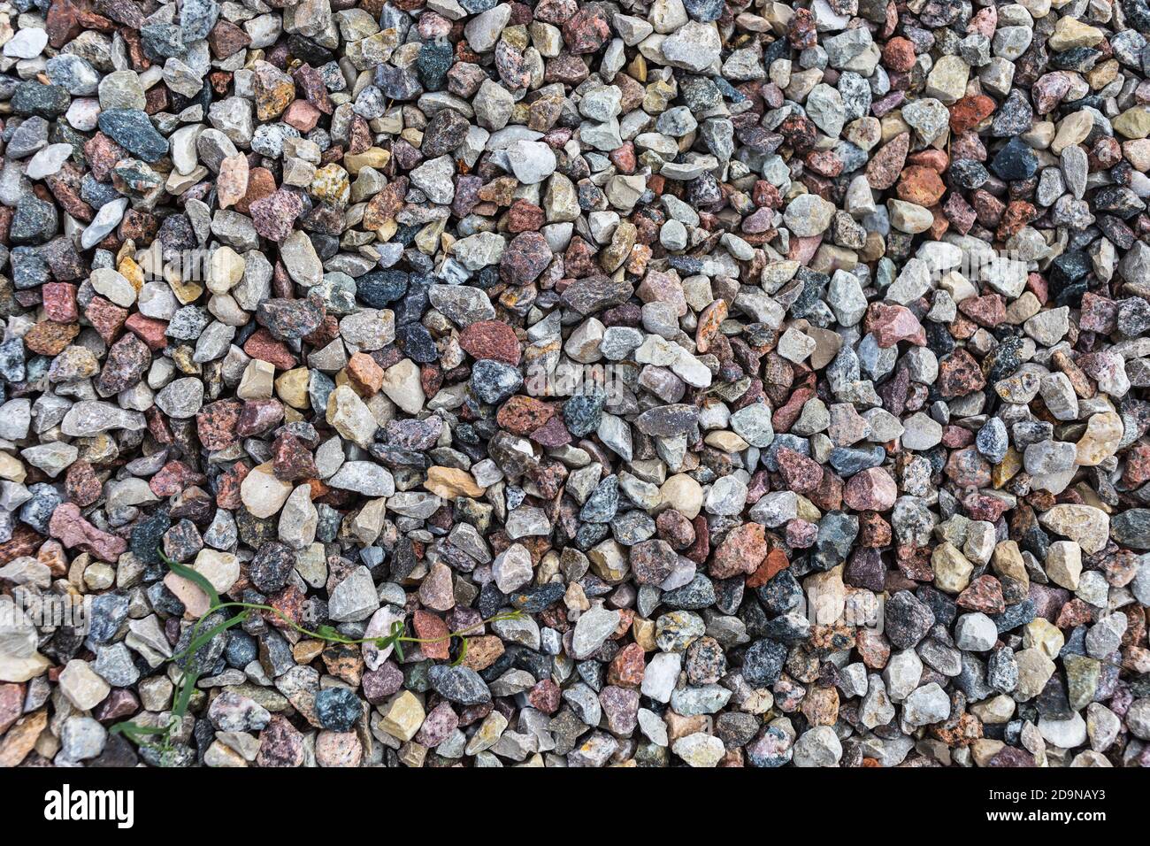 Different colored rocks and pebbles on a beach. Various colors and ...