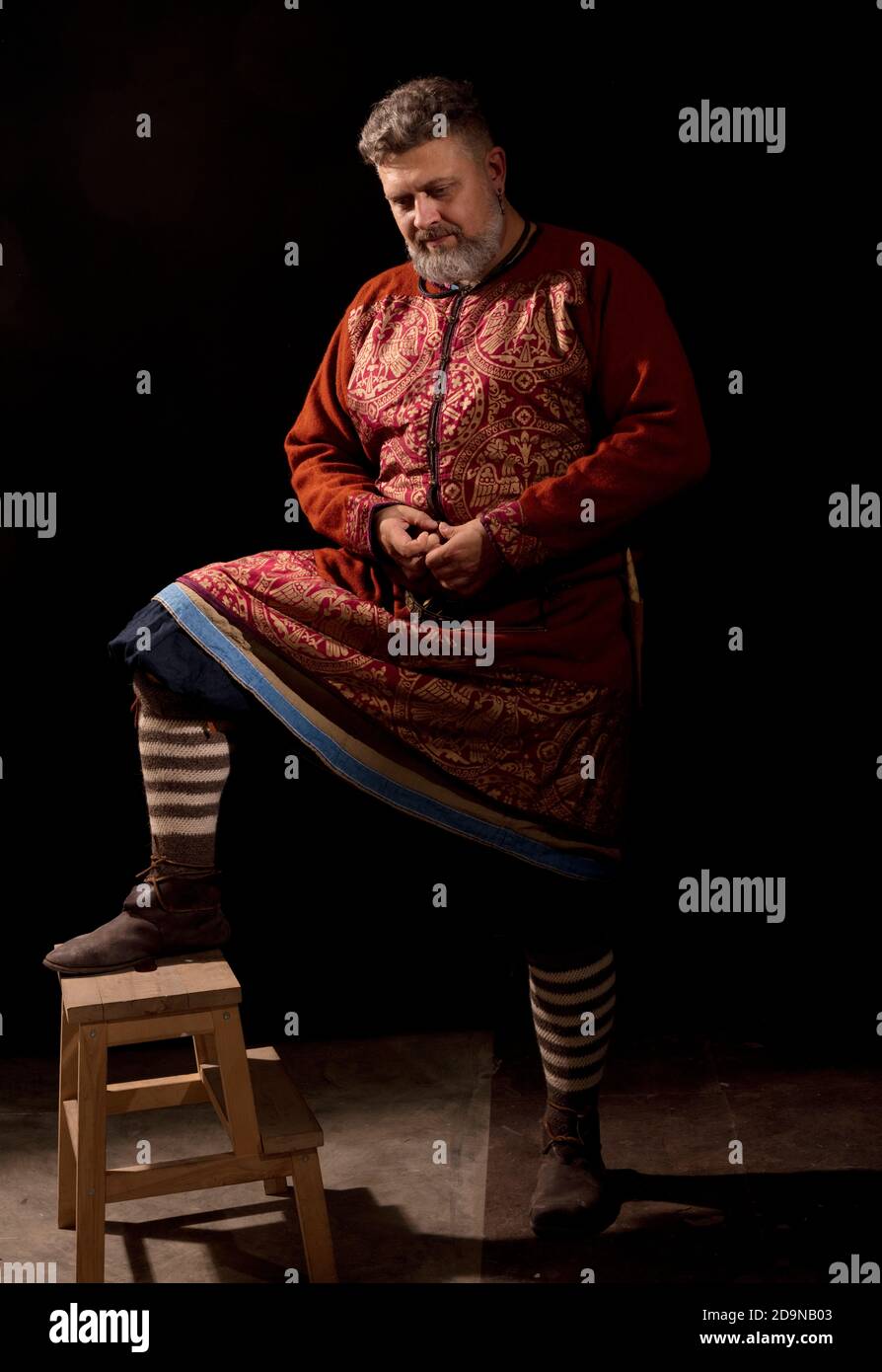 Mature bearded man in traditional historic clothes studio portrait ...