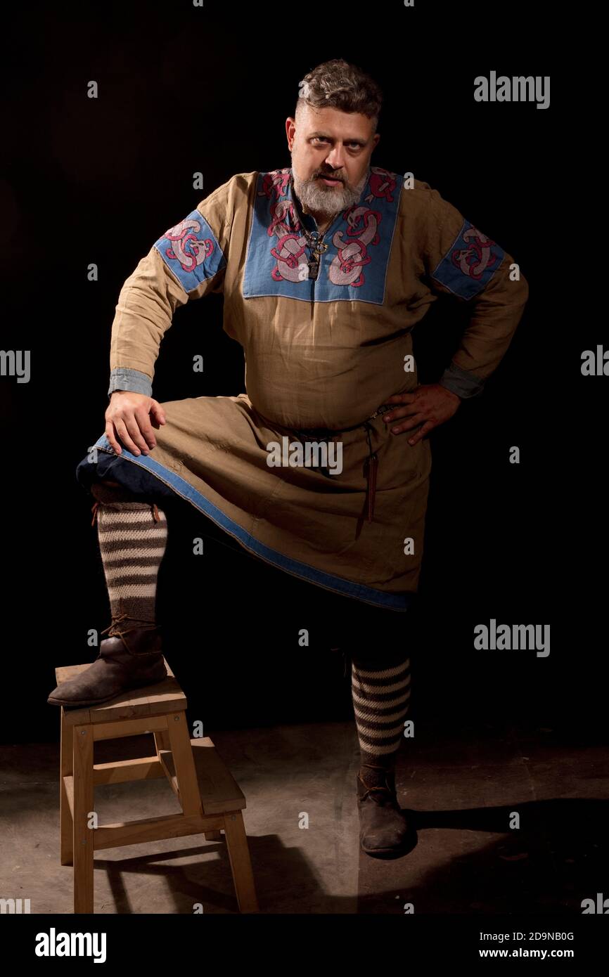 Mature bearded man in traditional historic clothes studio portrait ...
