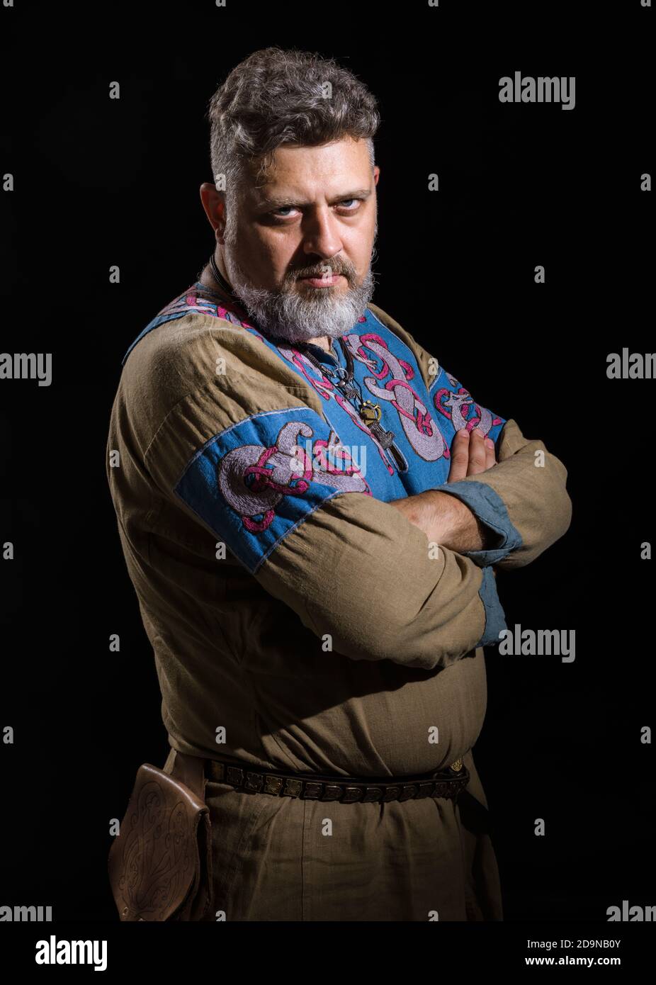 Mature bearded man in traditional historic clothes studio portrait ...