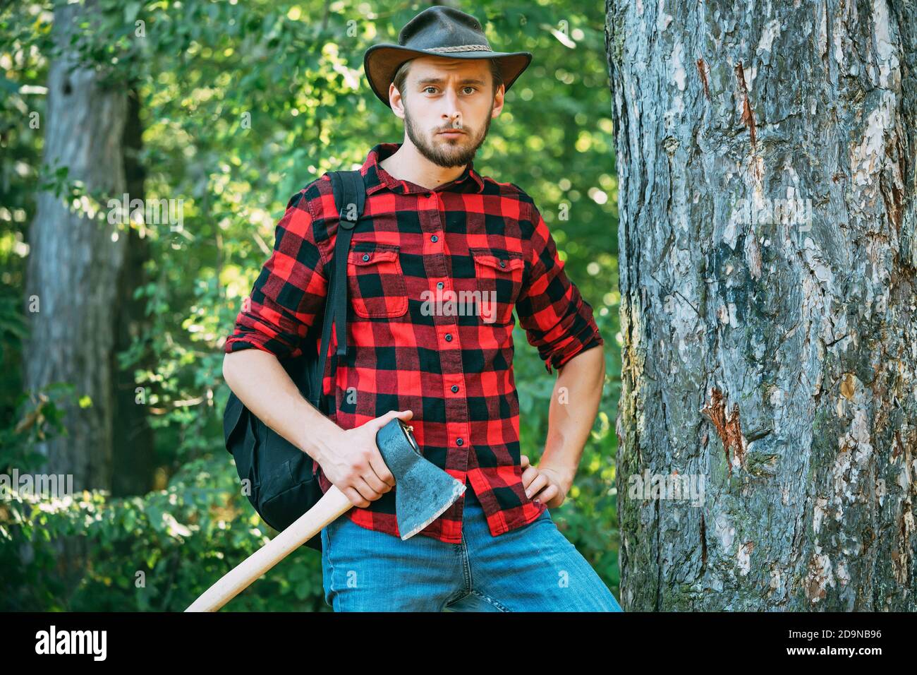 Handsome man with axe. Stylish young man posing like lumberjack ...