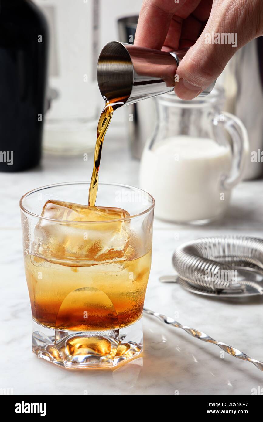 Mans hand pouring alcohol hi-res stock photography and images - Alamy