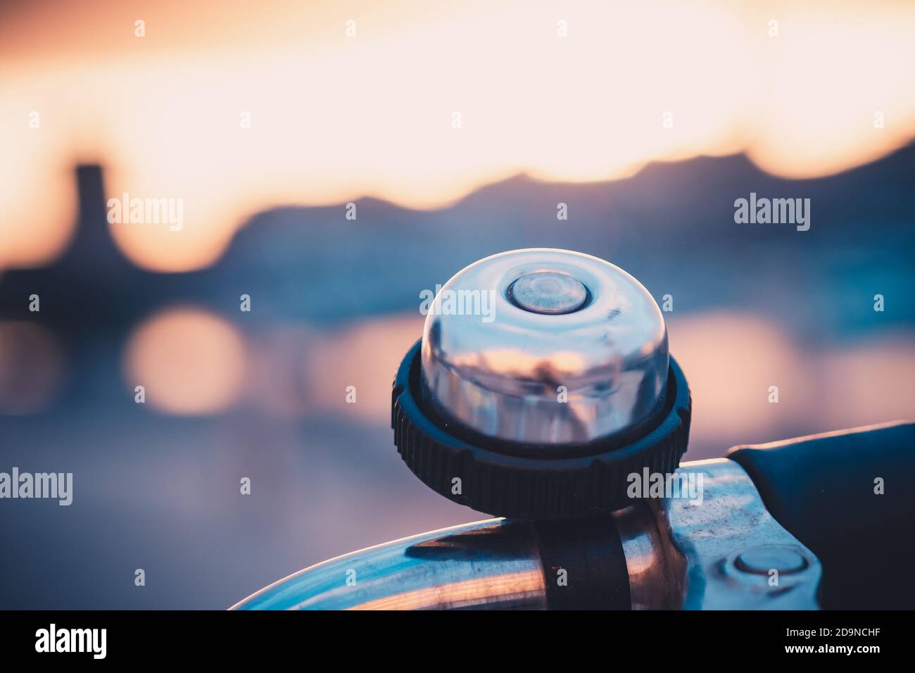 close-up of a bell ringer on the handle bars of bicycle in the old ...