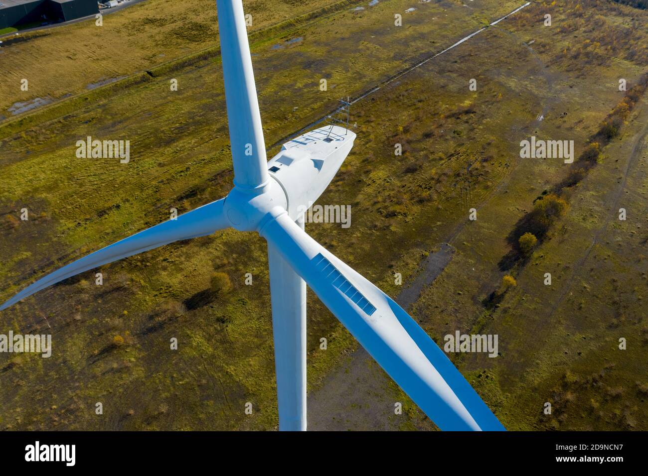 Aerial View of large wind turbine stationary on beautiful welsh ...