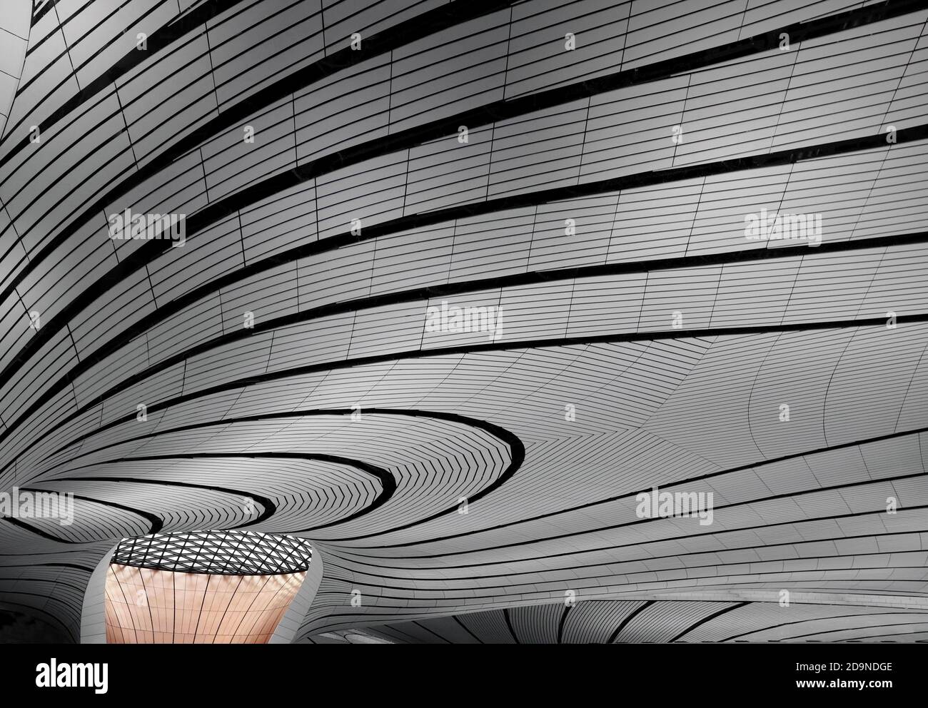 Artistic architectural wave design on the ceiling of a modern building ...