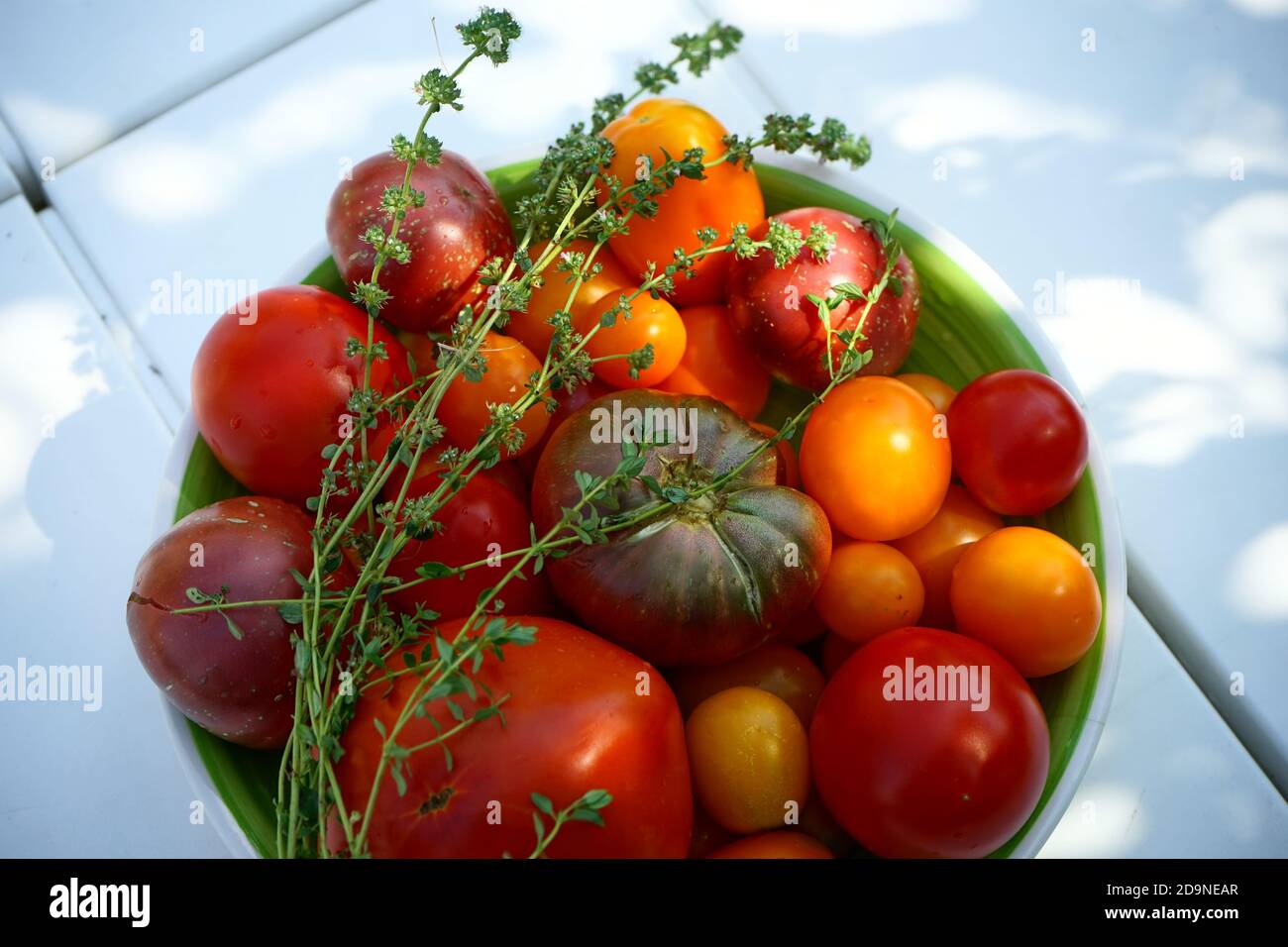 Organic tomato breeds: yellow, orange and red in a bowl Stock Photo - Alamy