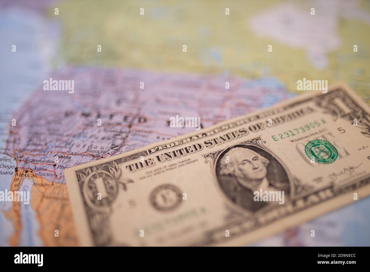 One-dollar bill on top of The United States of America on a colorful ...