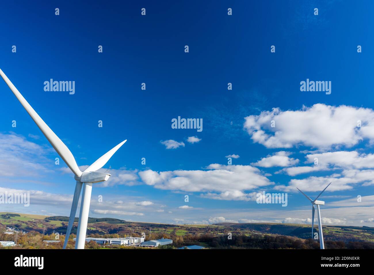 Aerial View of large wind turbine stationary on beautiful welsh ...
