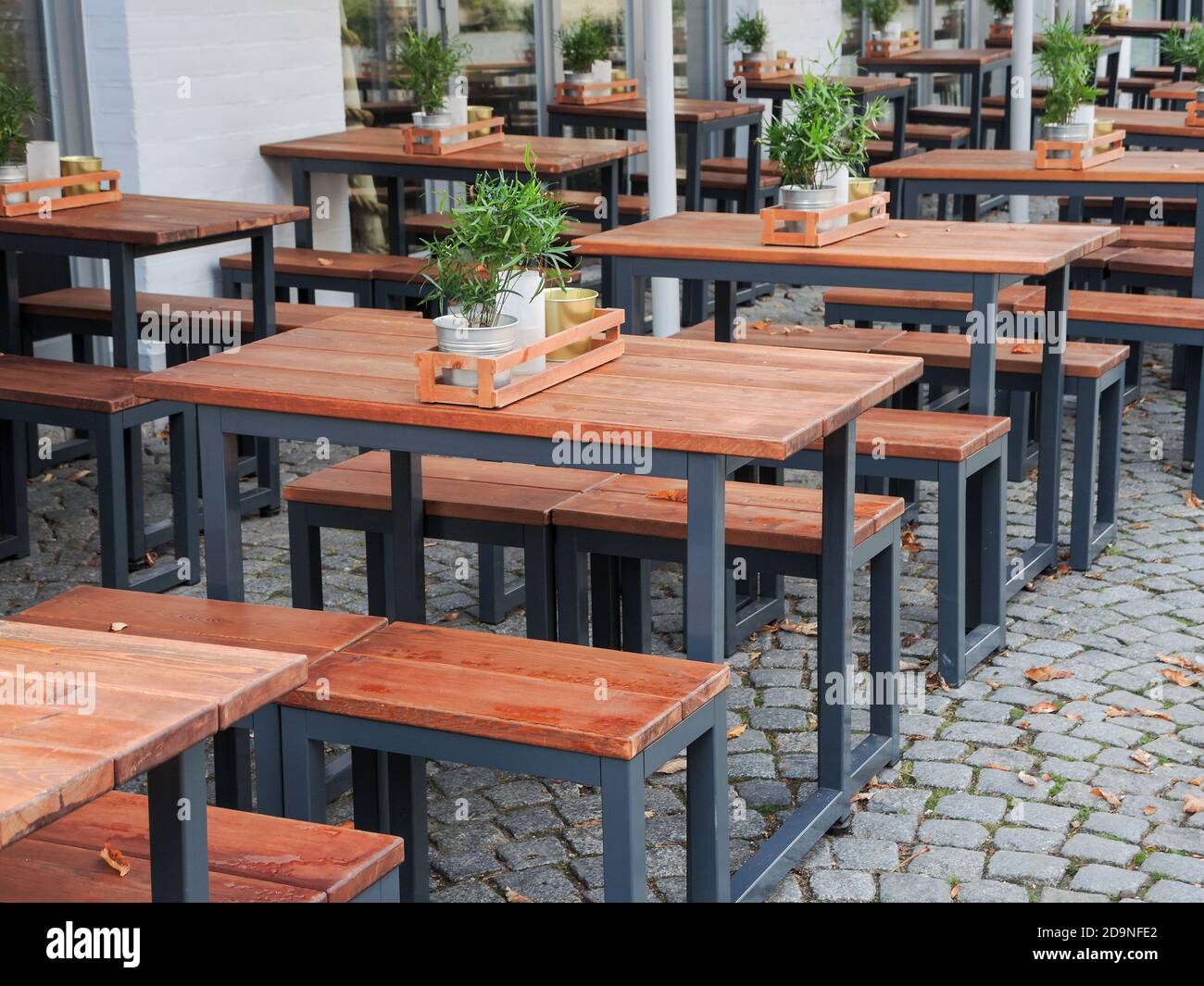 Benches and tables in front of a restaurant Stock Photo - Alamy