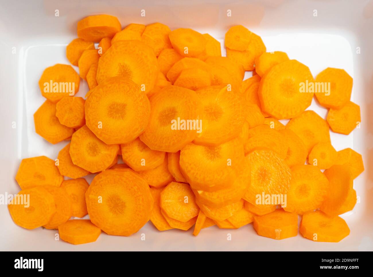 Cut carrots in a white bowl Stock Photo - Alamy