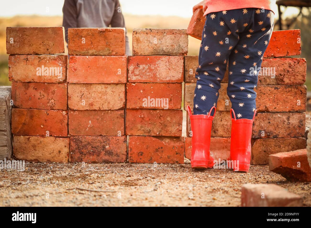 Children playing in backyard building a brick wall Stock Photo - Alamy