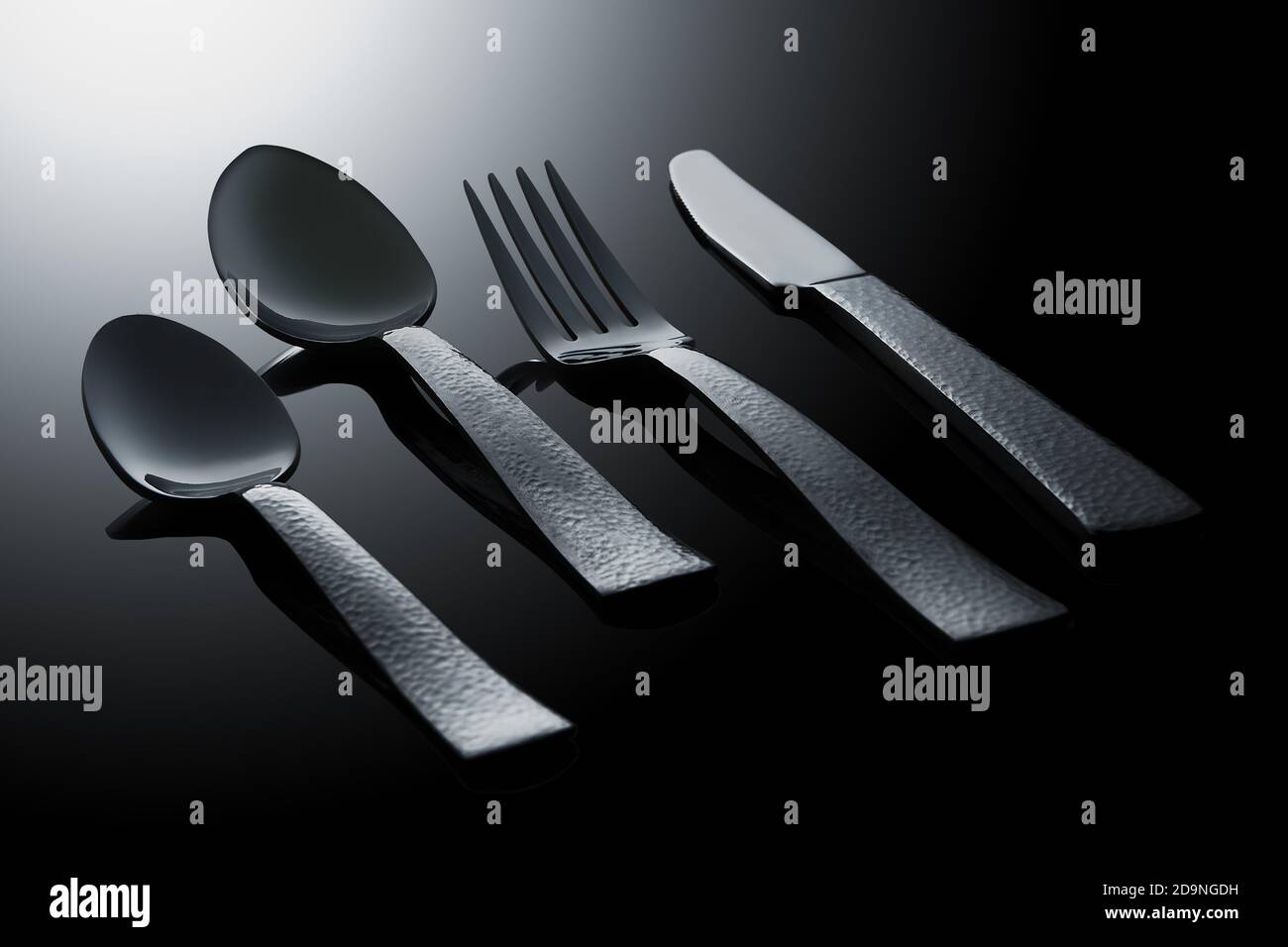 Closeup shot of flatware on a black surface Stock Photo - Alamy