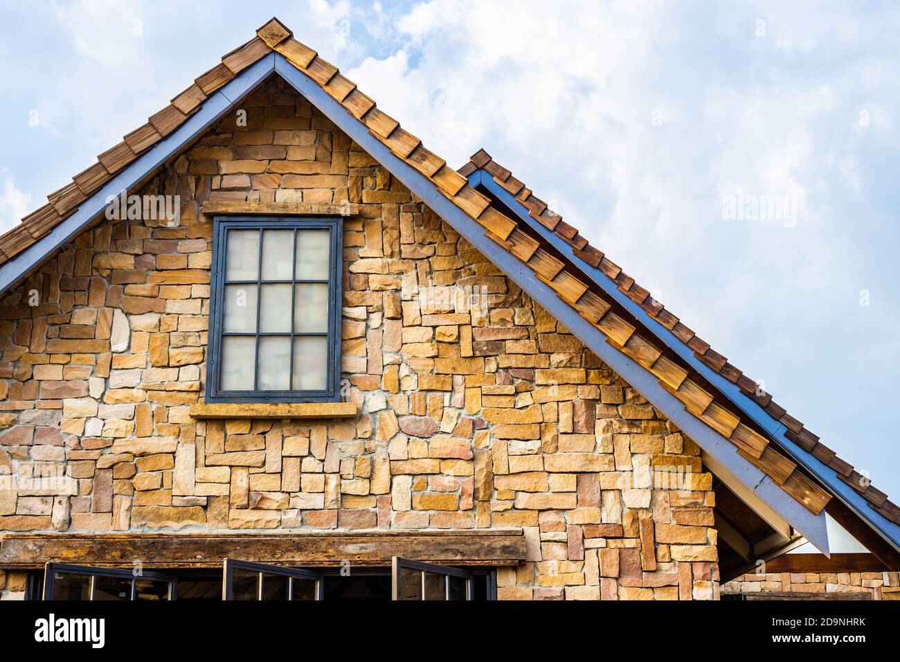 roof of the house with nice window and built with classic style stone ...