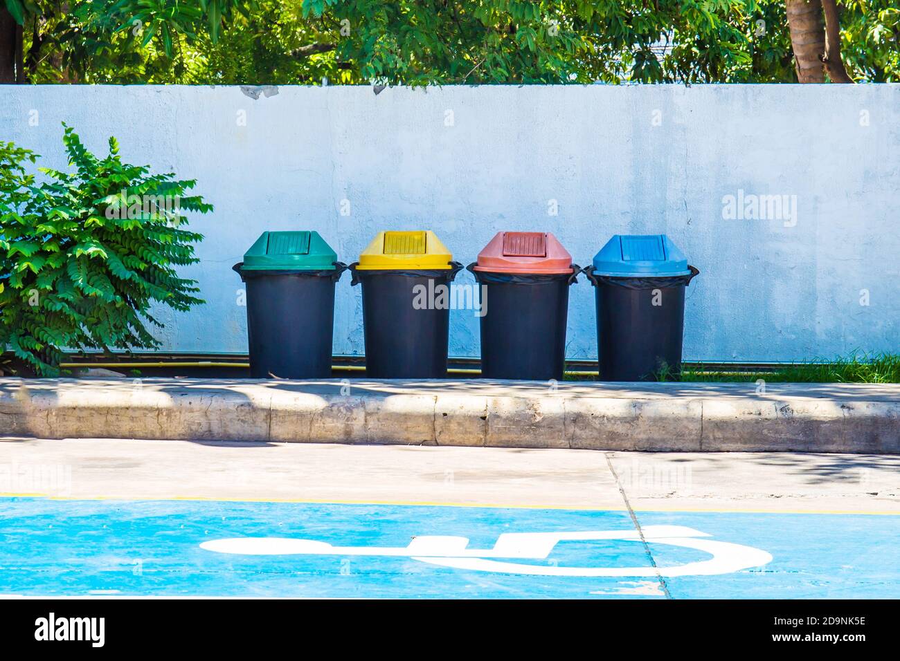 Trash bins of many colors to separate the types of trash located in ...