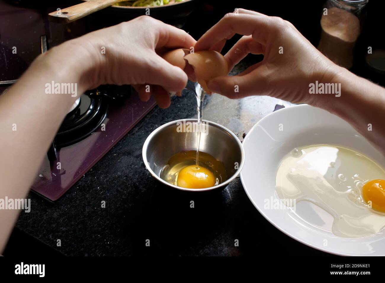 Woman breaking eggs hi-res stock photography and images - Alamy