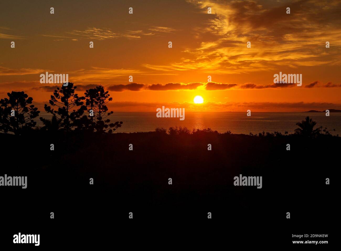 Mesmerizing view of a beautiful sunset over a calm sea surrounded by ...