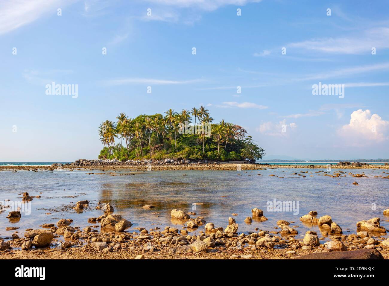 Small island in tropical sea with blue ocean and blue sky white clouds ...