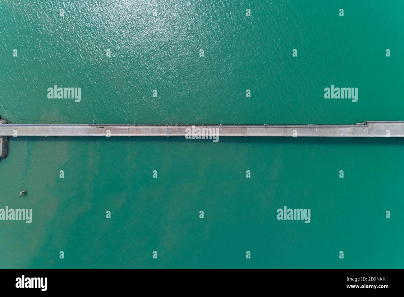 Aerial top view drone shot of small bridge in the sea image ...