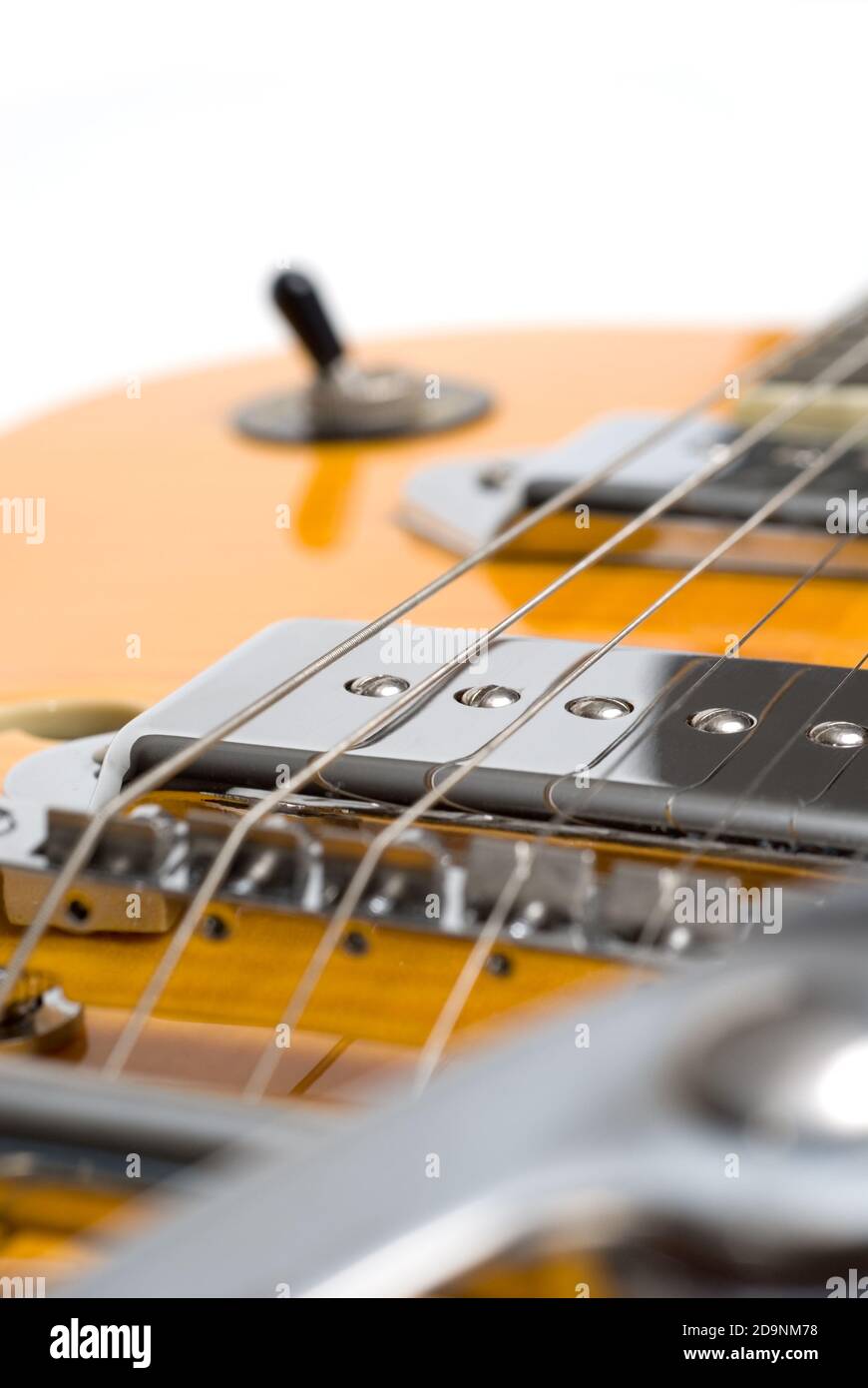 Detail of a semi-hollow bodied electric guitar, focus is on strings ...