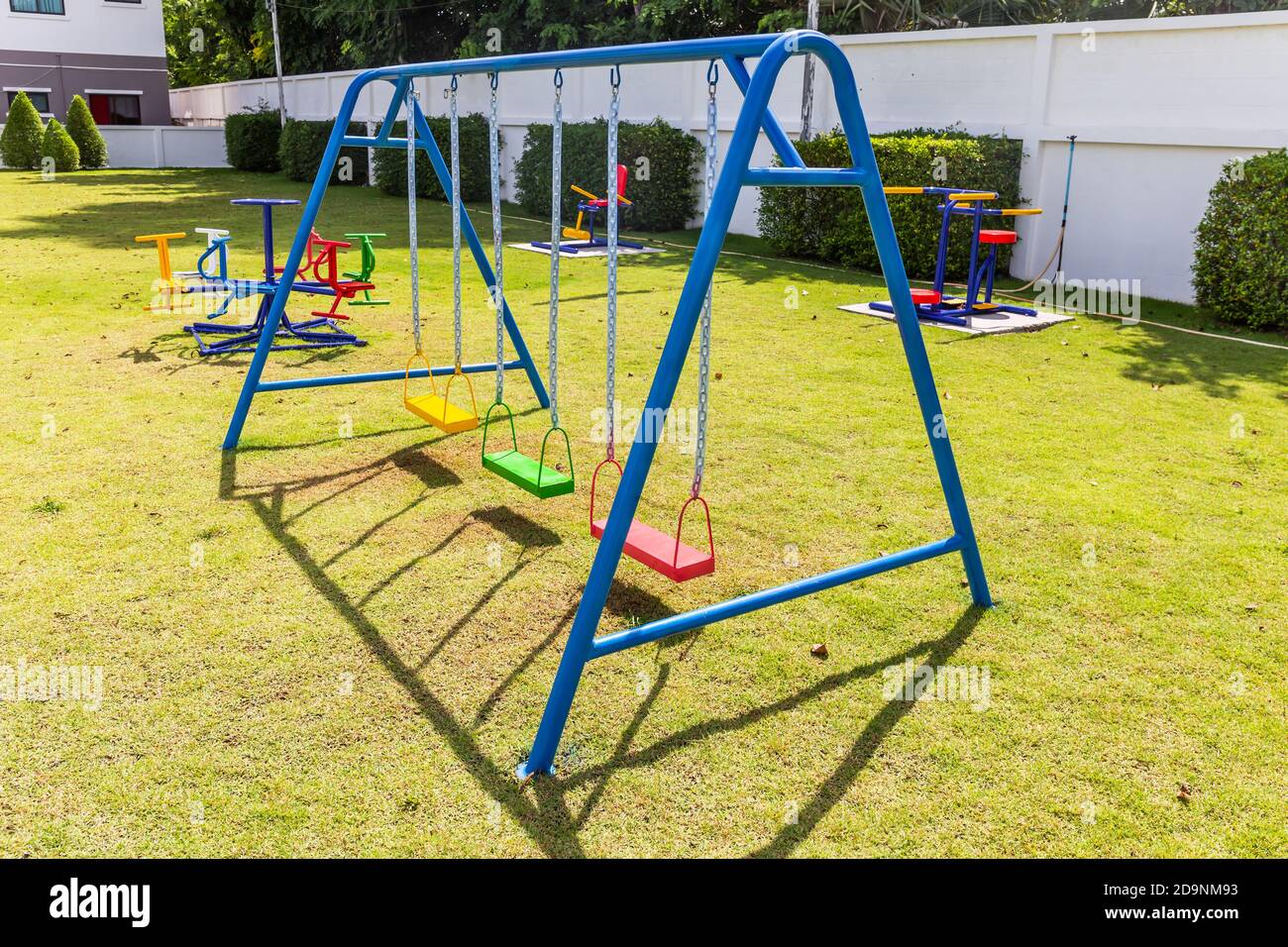 Colorful swing playground and exercise at grass field outdoor public ...