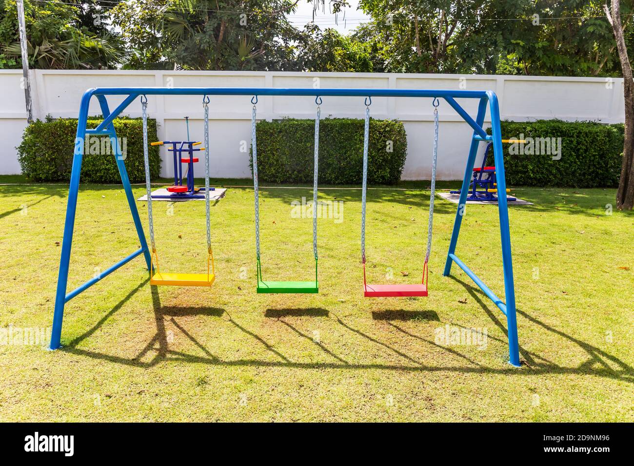 Colorful swing playground and exercise at grass field outdoor public ...