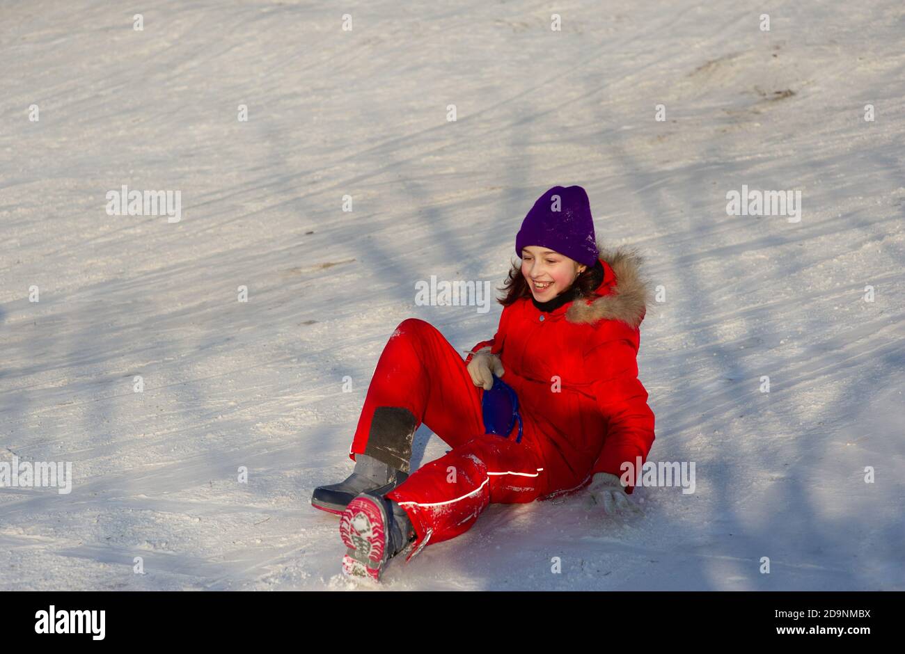 Little teenager girl in beautiful warm red outfit playing outdoors in ...