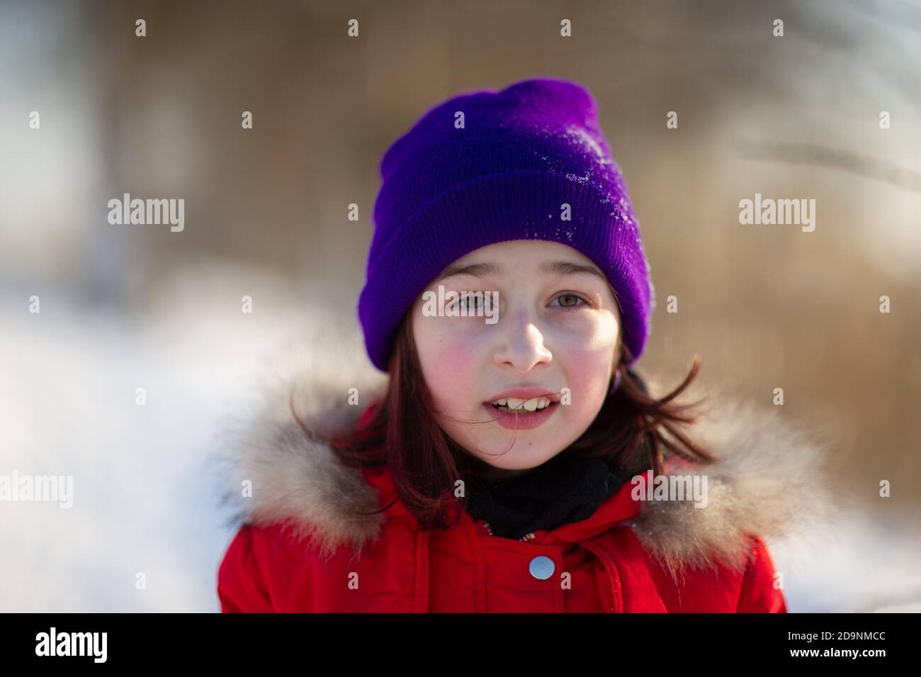 Little teenager girl in beautiful warm red outfit playing outdoors in ...