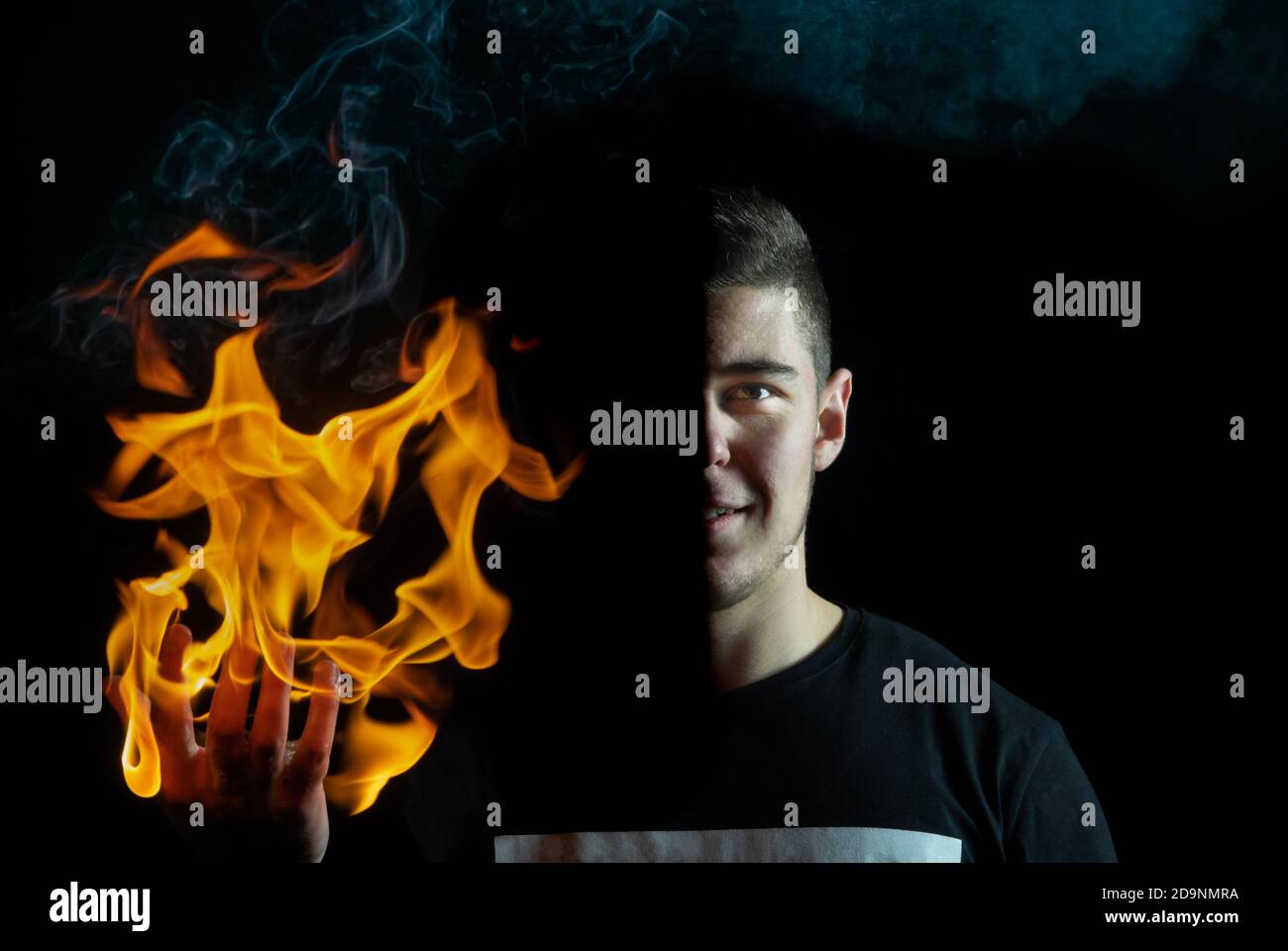 A portrait of a guy holding fire in right hand, (Half face portrait ...