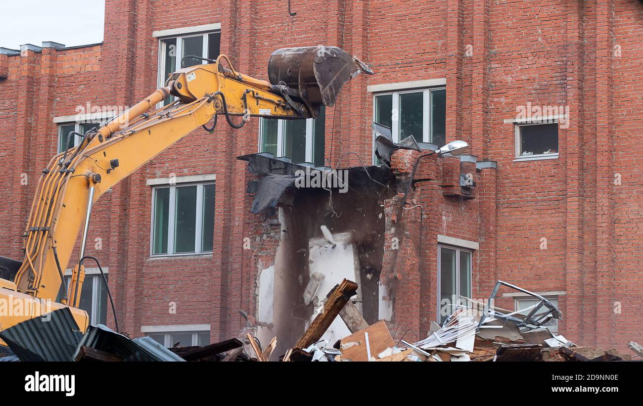 Construction equipment breaks the building, a large excavator ...