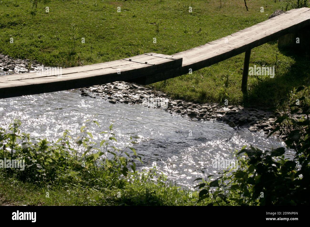 Simple wooden bridge over a creek in Romania's countryside Stock Photo ...