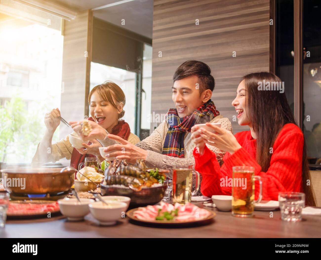 happy friends having fun in hot pot restaurant Stock Photo - Alamy