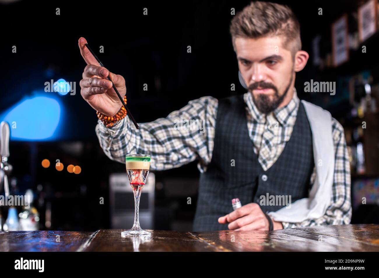 Bartender creates a cocktail in the saloon Stock Photo - Alamy