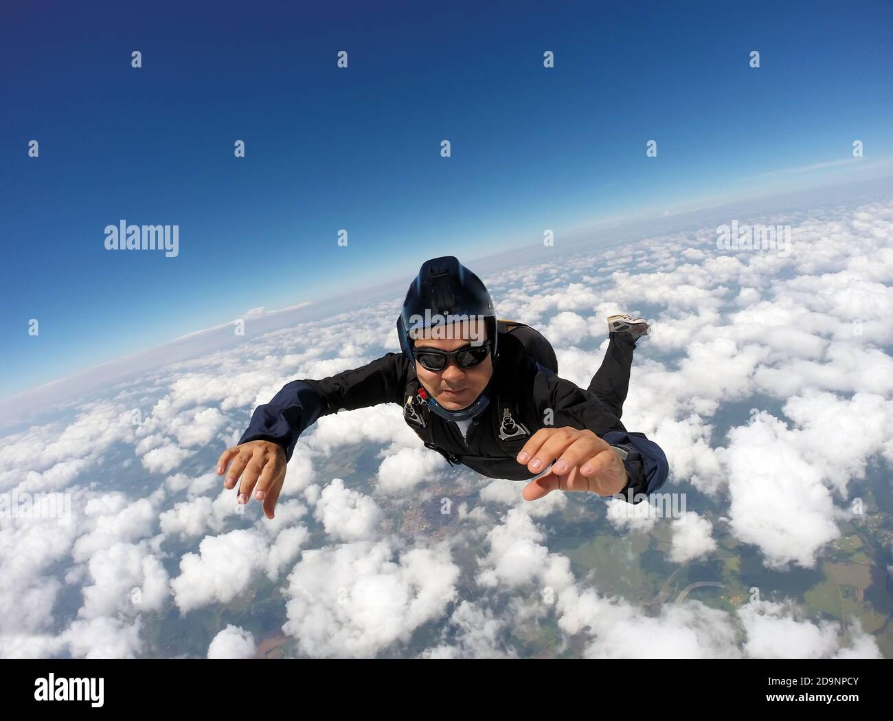 Skydiver Cloudscape speed dive to the ground Stock Photo - Alamy