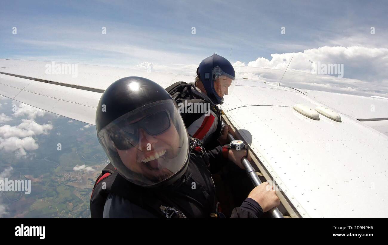 A group of friends holding hands teamwork in skydiving, soft focus on ...