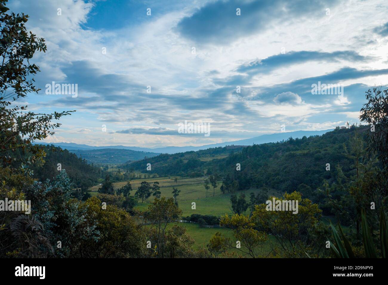 A beautiful view of a landscape surrounded by mountains gleaming under ...