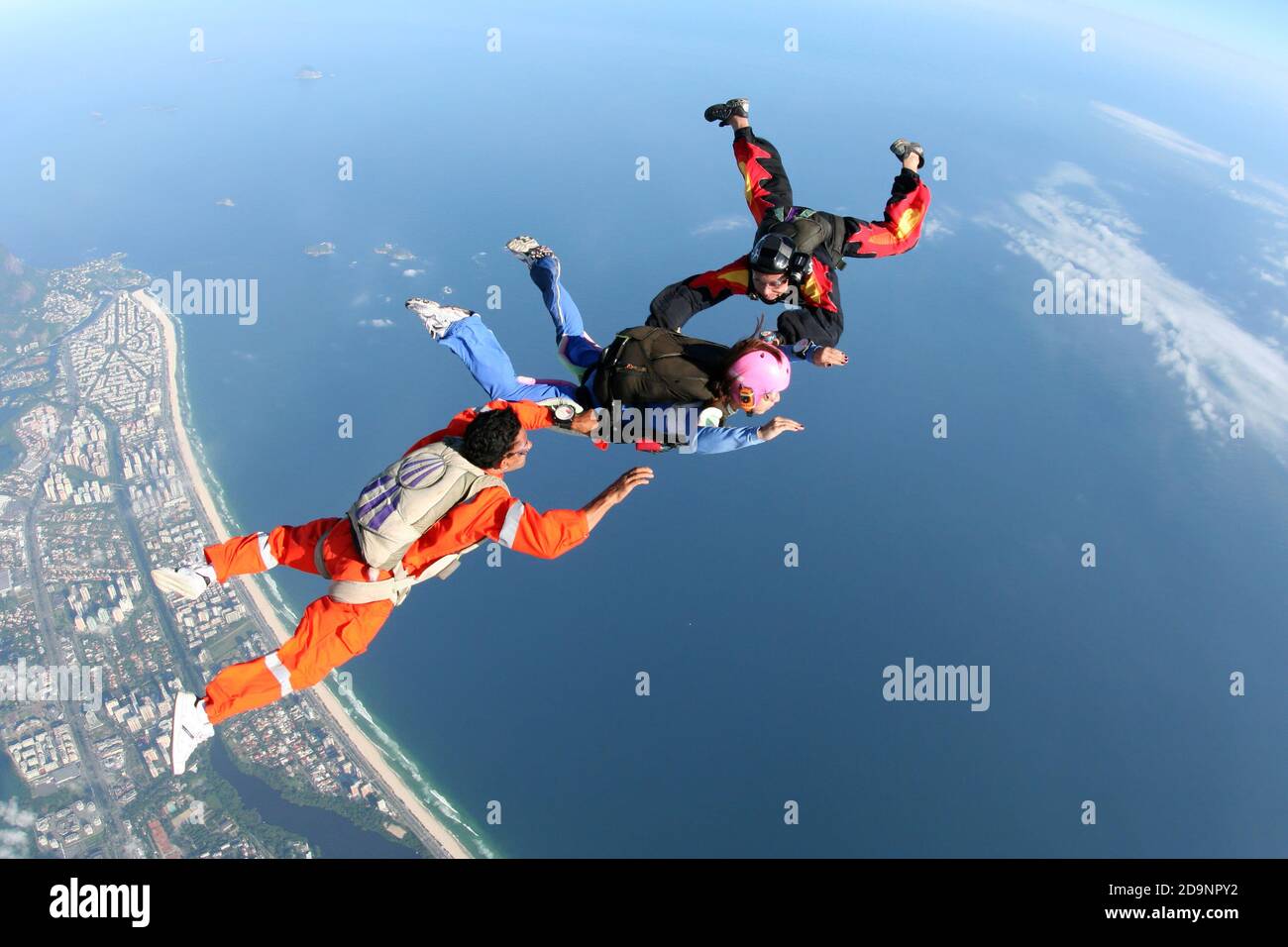Skydiving group over the coast Stock Photo - Alamy