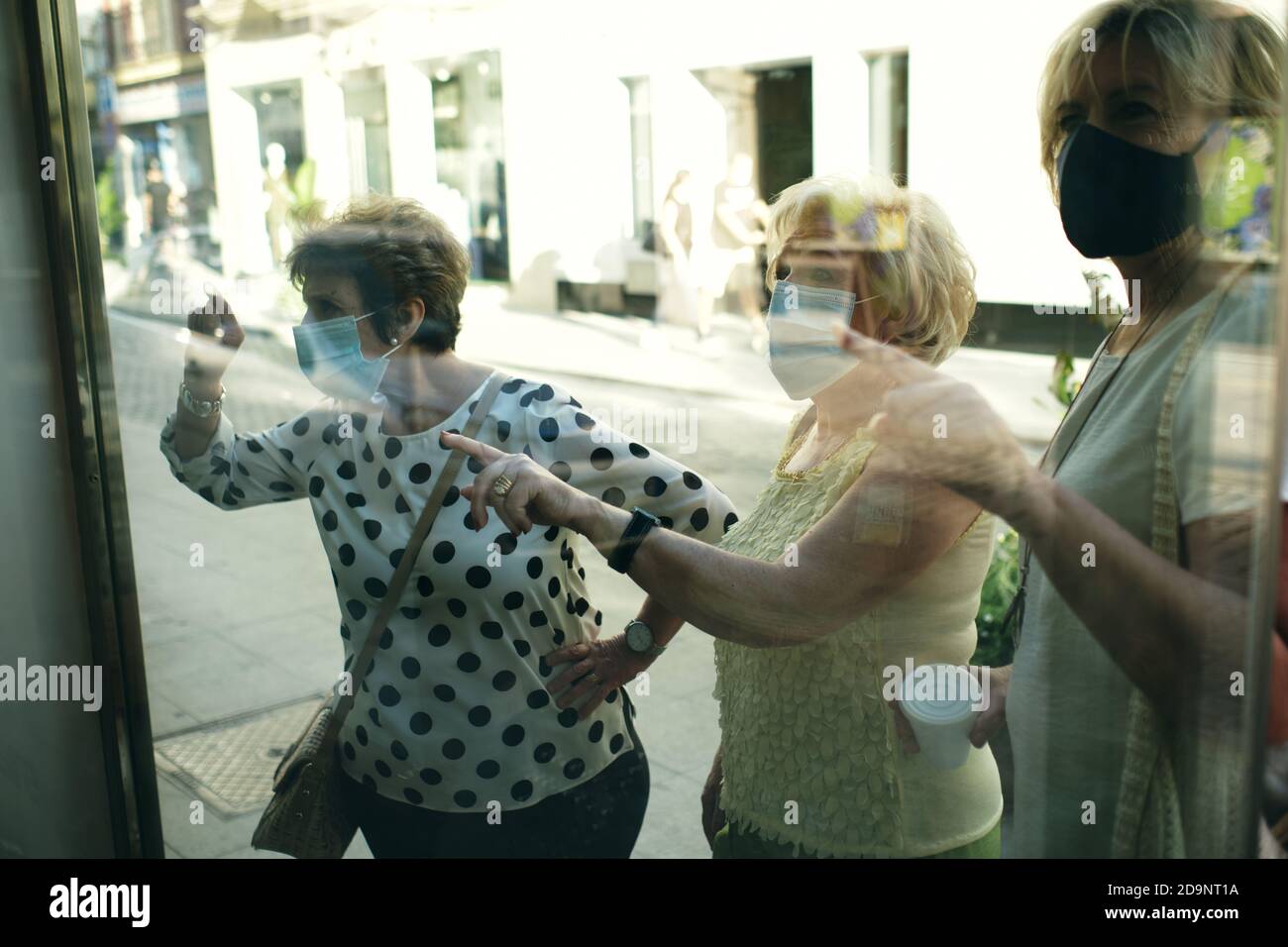 women looking and pointing in a window Stock Photo - Alamy