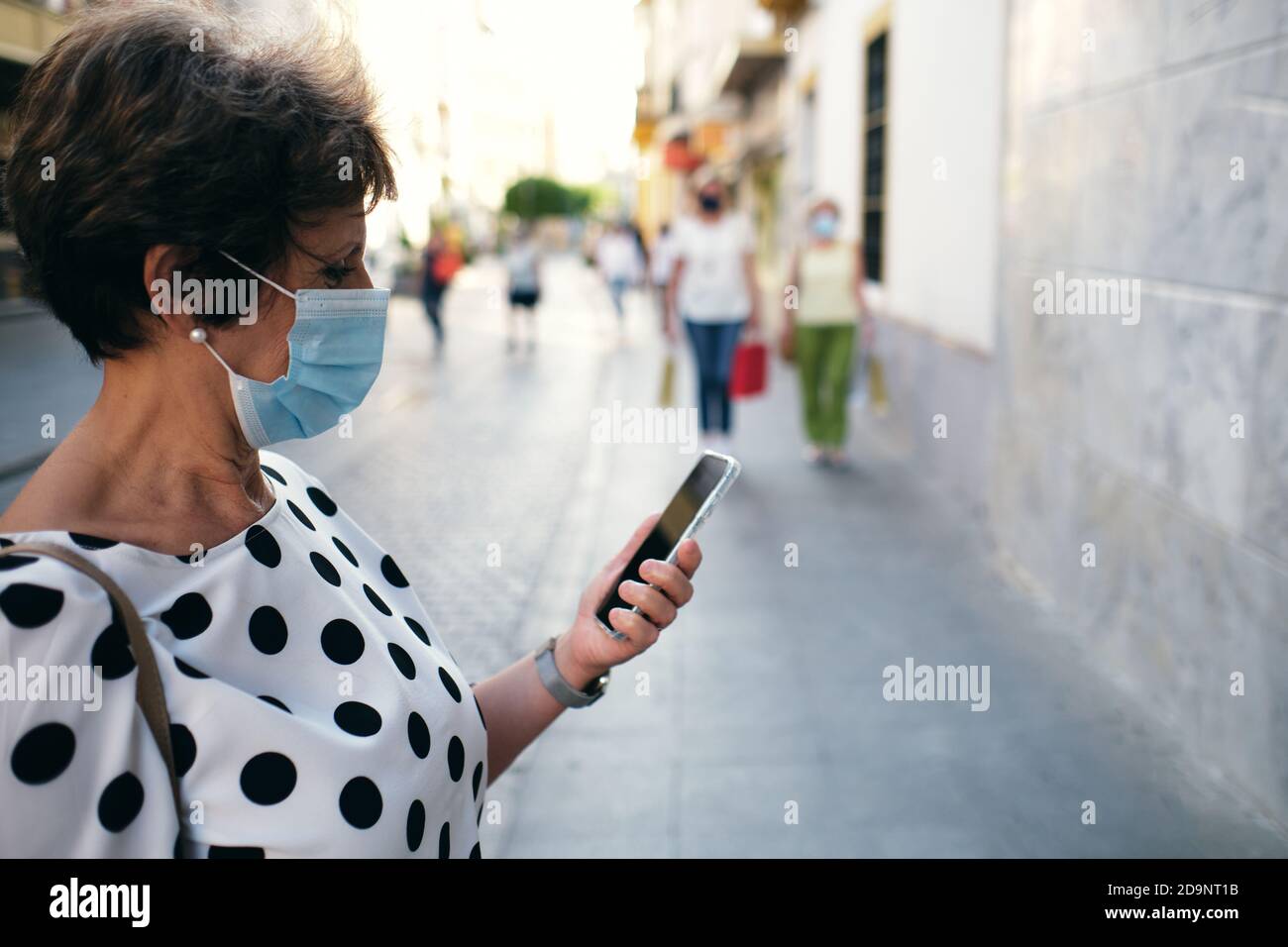 woman looked at her cell phone during a walk Stock Photo - Alamy