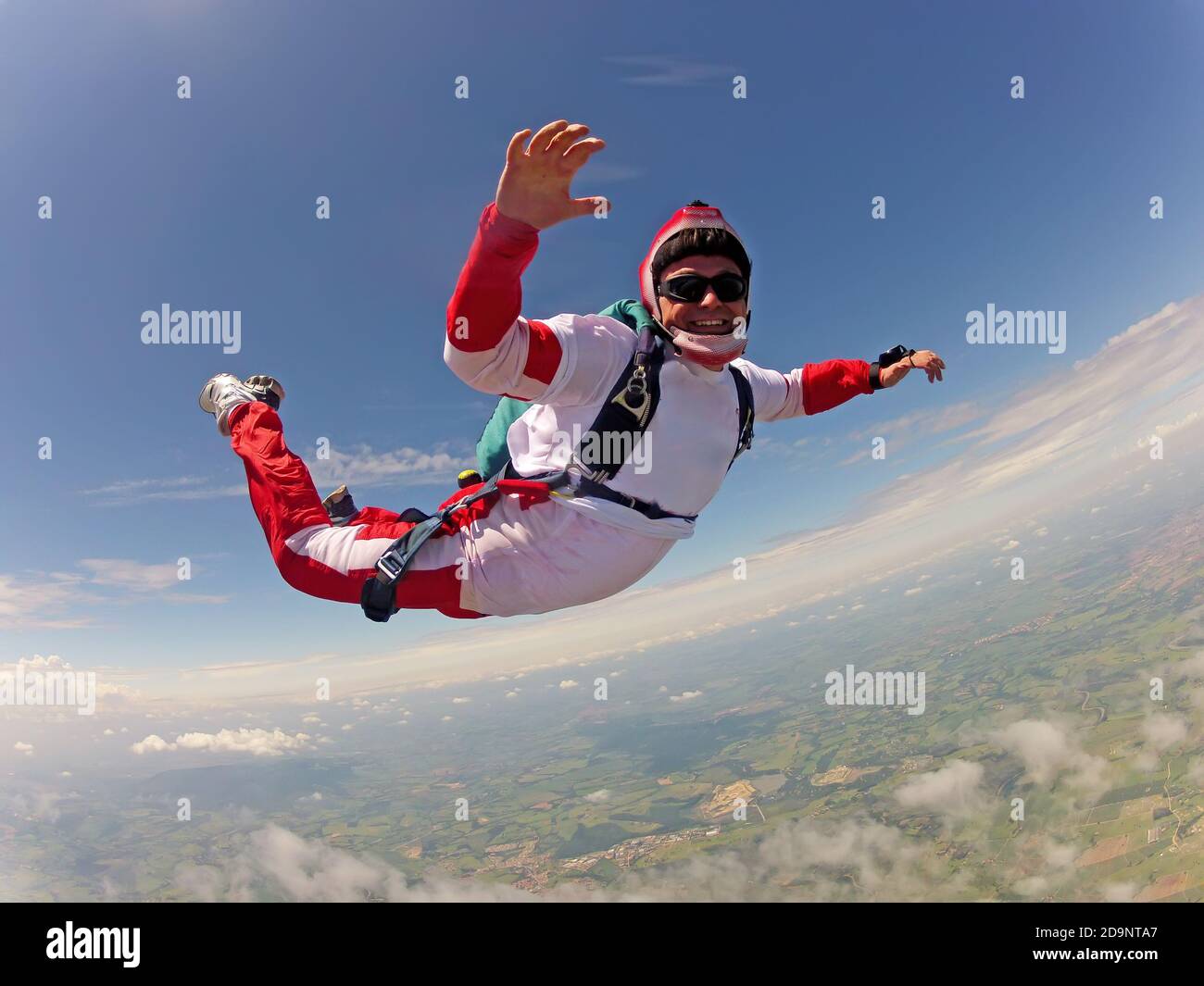 Red Skydiver classic position free fall Stock Photo - Alamy