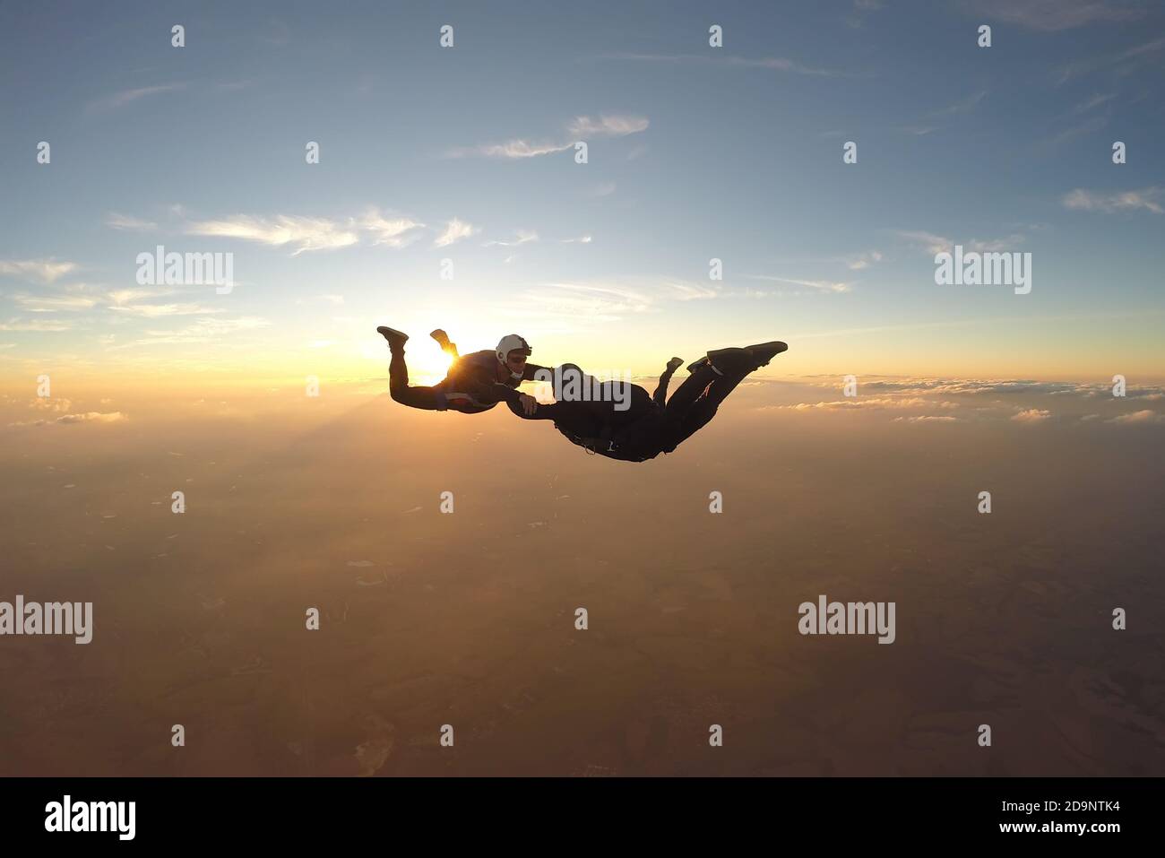 Skydiving at the sunset Stock Photo - Alamy