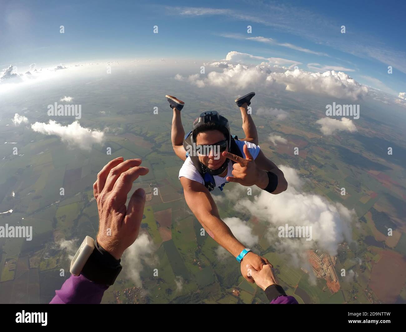 Skydiver hand shake point of view Stock Photo - Alamy