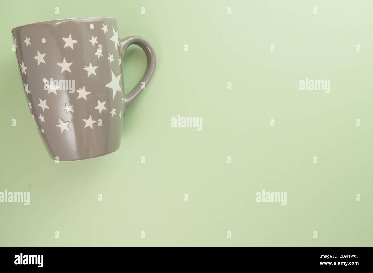 A top view closeup of a ceramic light grey mug with stars isolated on a ...