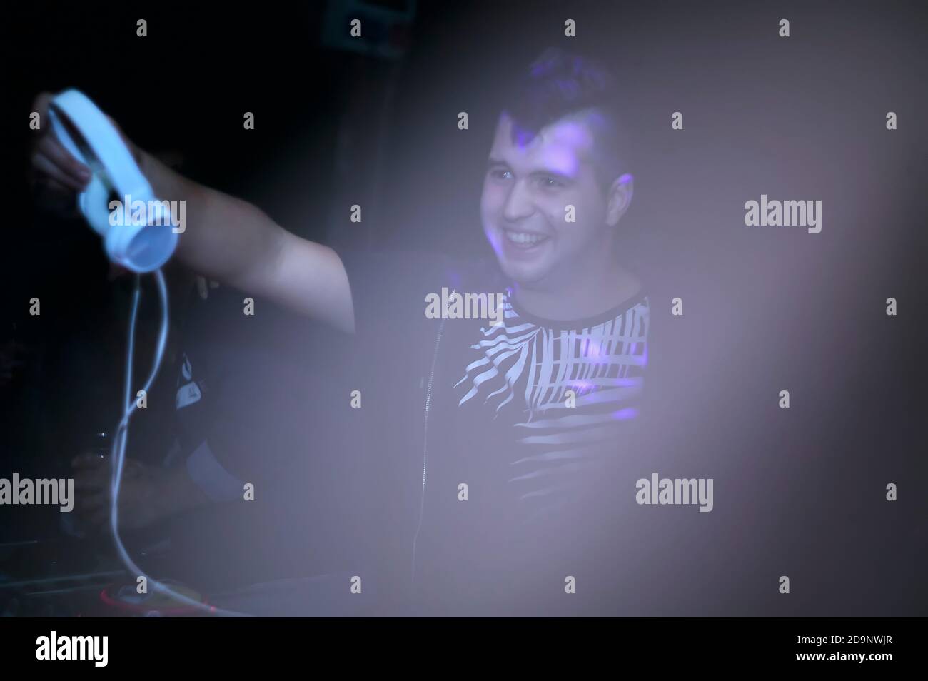Dj in action on a disco night with light and smoke effects Stock Photo ...