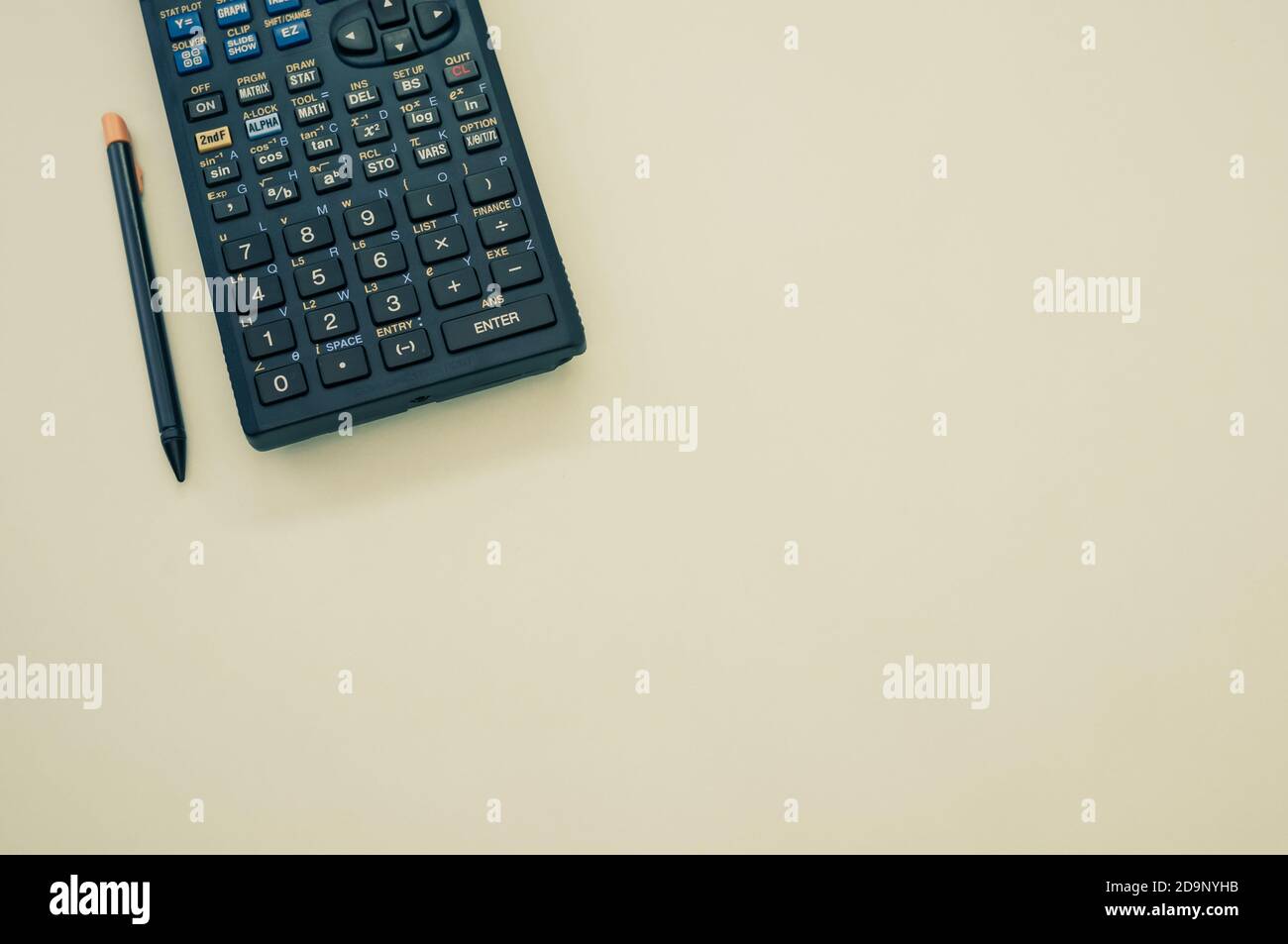A top view closeup of a graphing calculator and a pen isolated on a ...