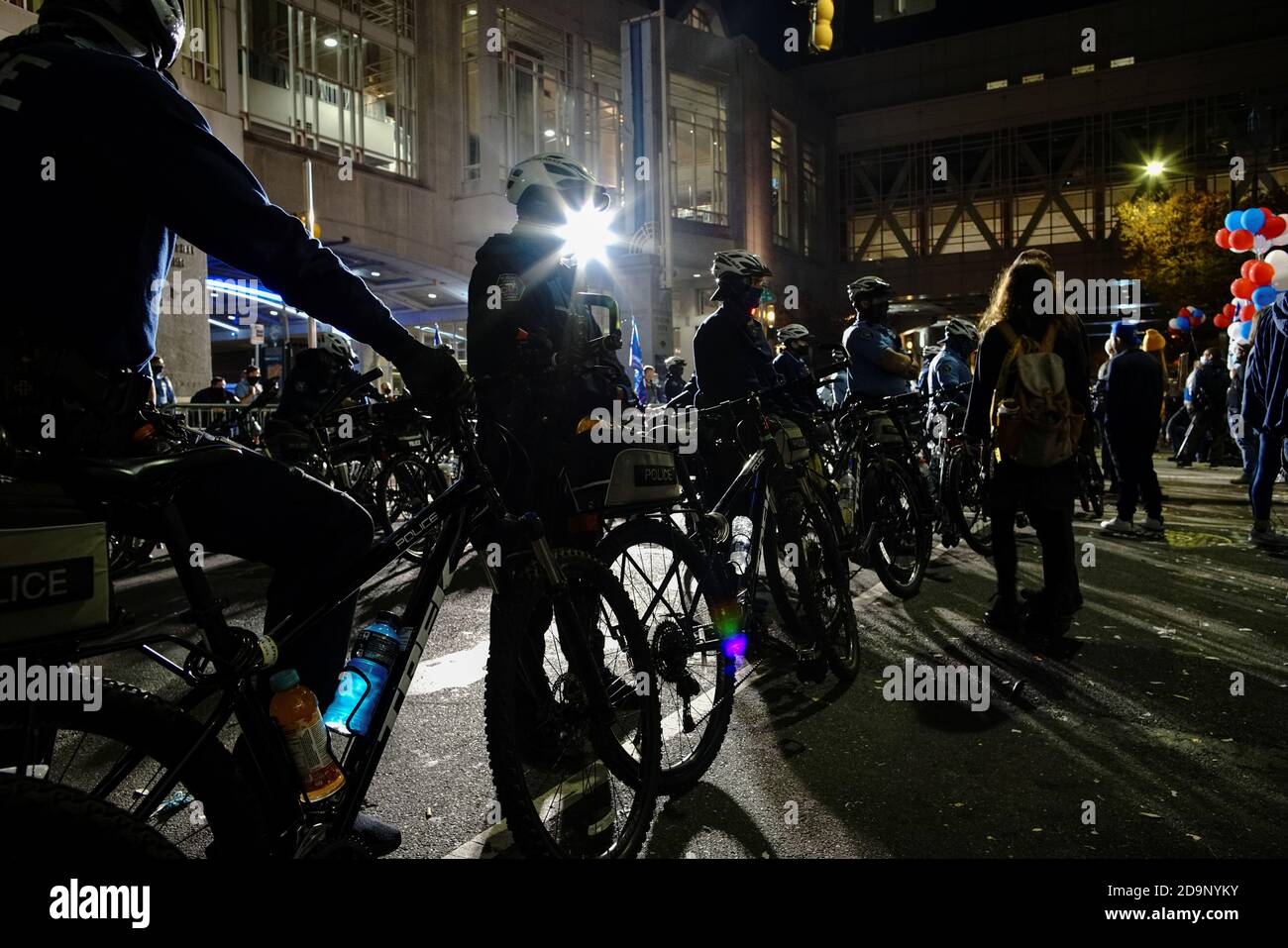 Police officers stand guard as votes continue to be counted following ...