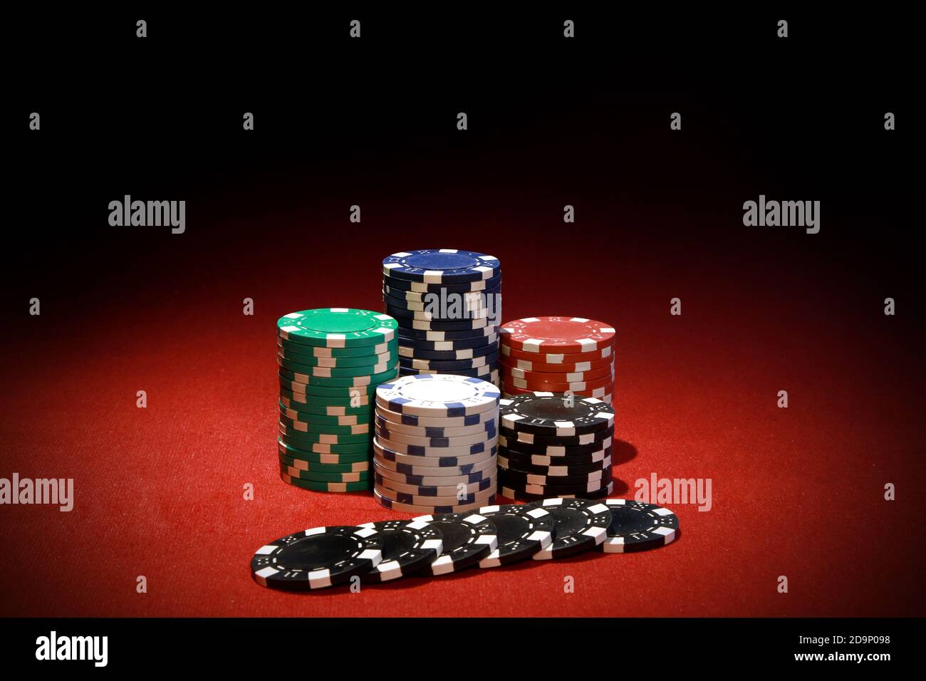 The stacks of colorful poker chips on a red table Stock Photo - Alamy
