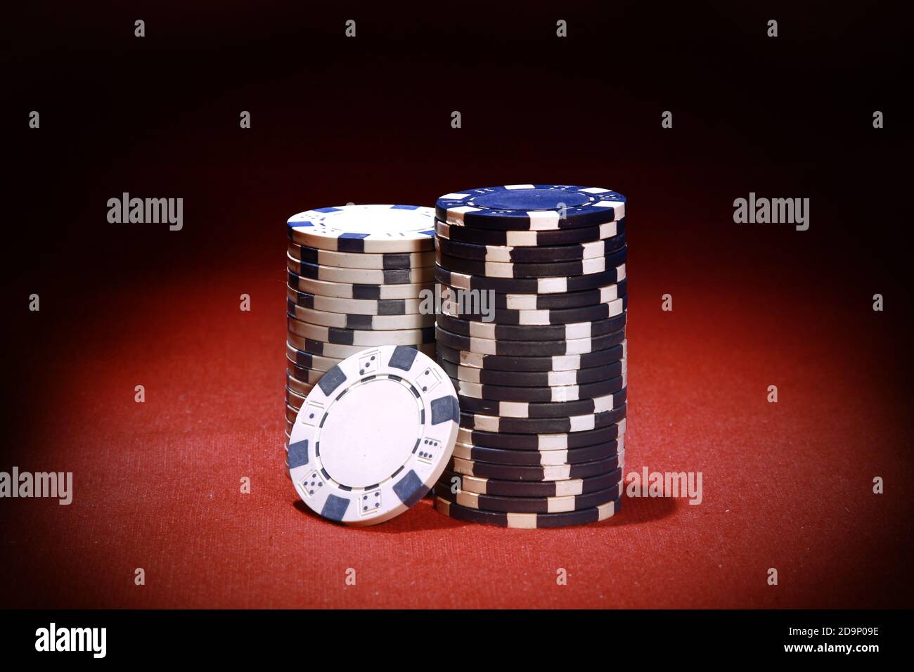 The stacks of blue and white poker chips on a red table Stock Photo - Alamy