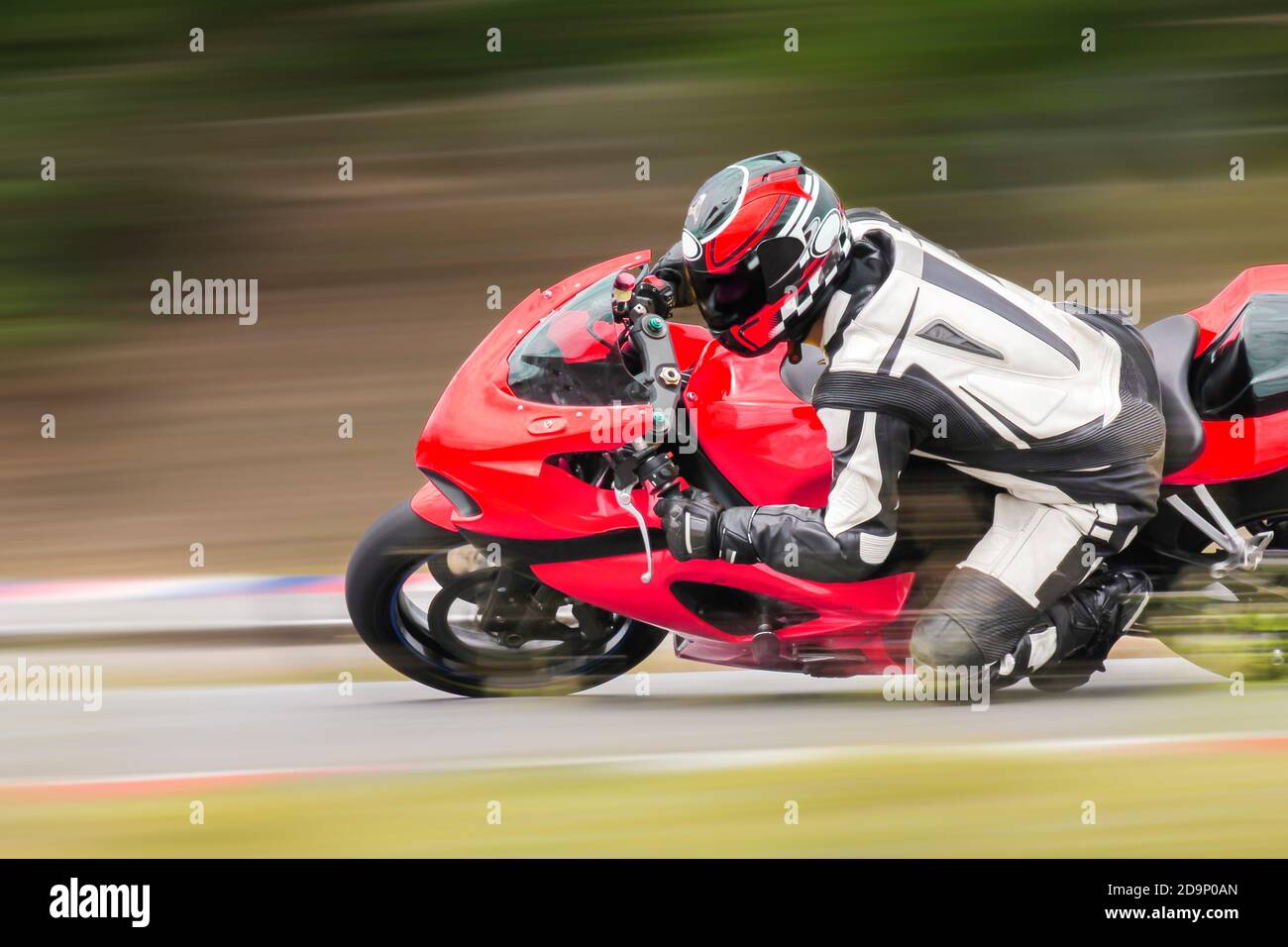 Motorcycle practice leaning into a fast corner on track Stock Photo - Alamy